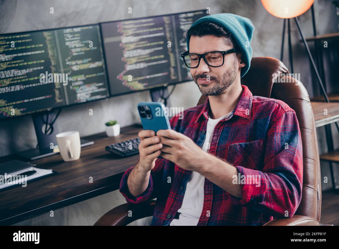 Photo of cheerful happy programmer wear spectacles typing message ...