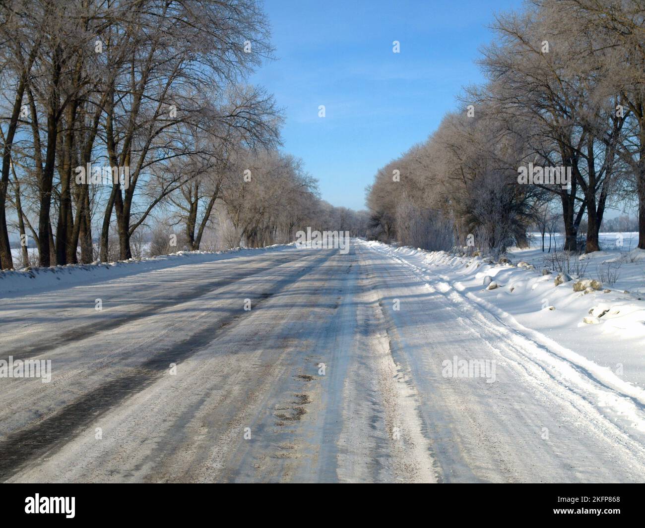 Winter and snowy road outside the city. Icing of the road. Landscape of ...