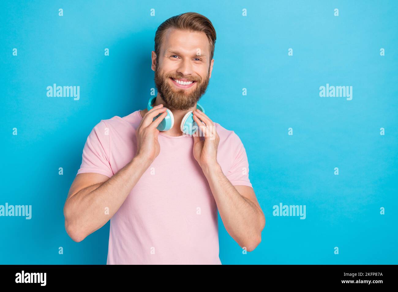 Photo portrait of nice young guy arms touch headphones toothy smile ...