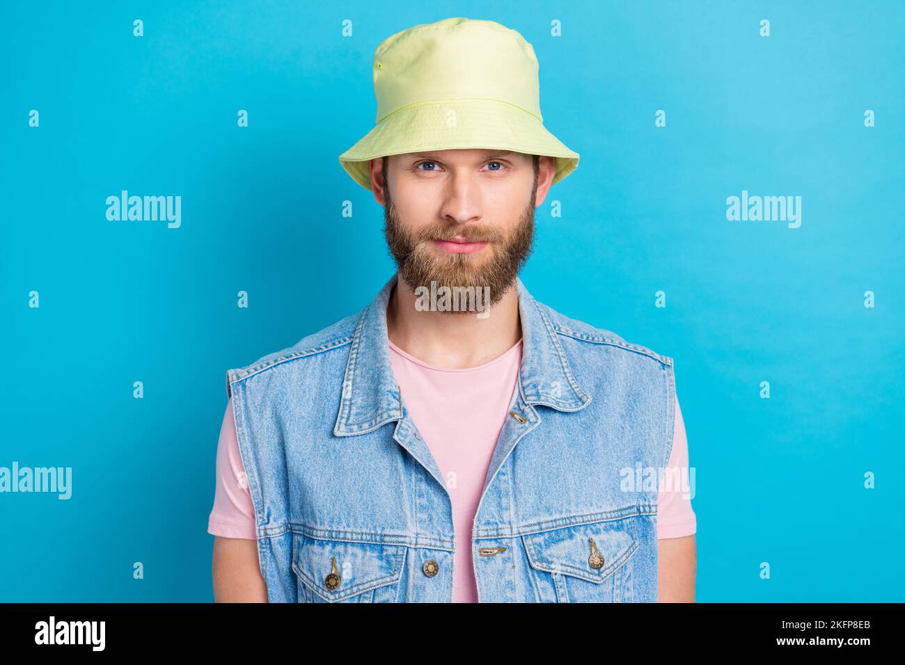 Photo of cheerful positive young man wear jeans waistcoat green panama ...