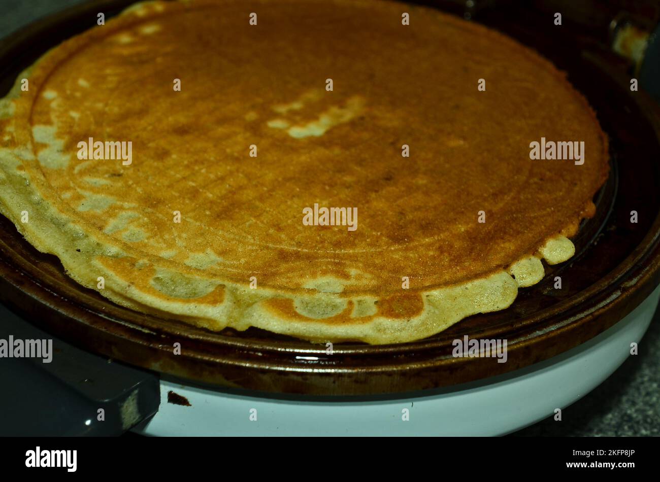 a wafer baked from paste in a waffle iron Stock Photo - Alamy