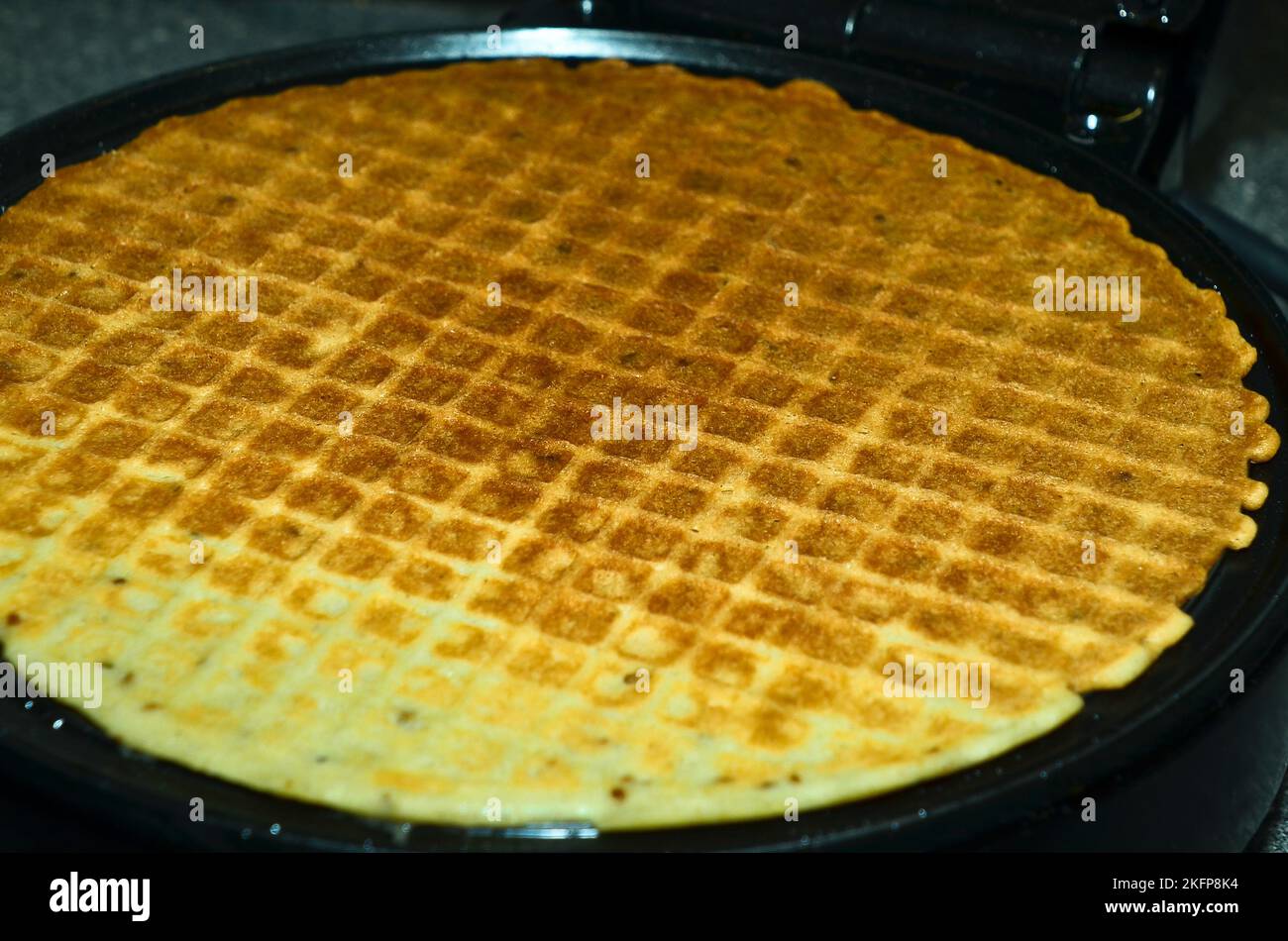 a wafer baked from paste in a waffle iron Stock Photo - Alamy