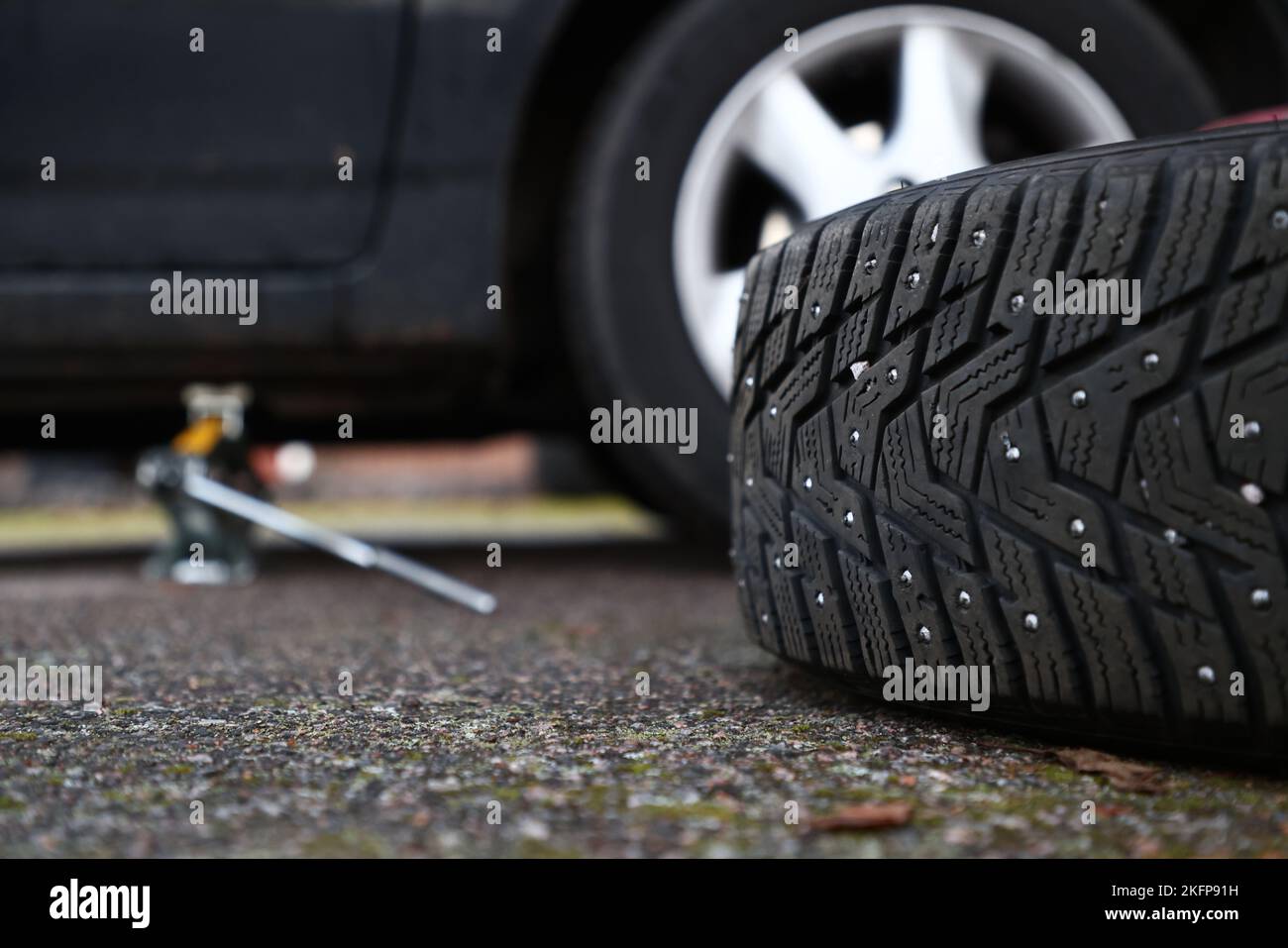 Someone changing wheels, from summer tires to winter tires Stock Photo ... Someone changing wheels, from summer tires to winter tires Stock Photo ...