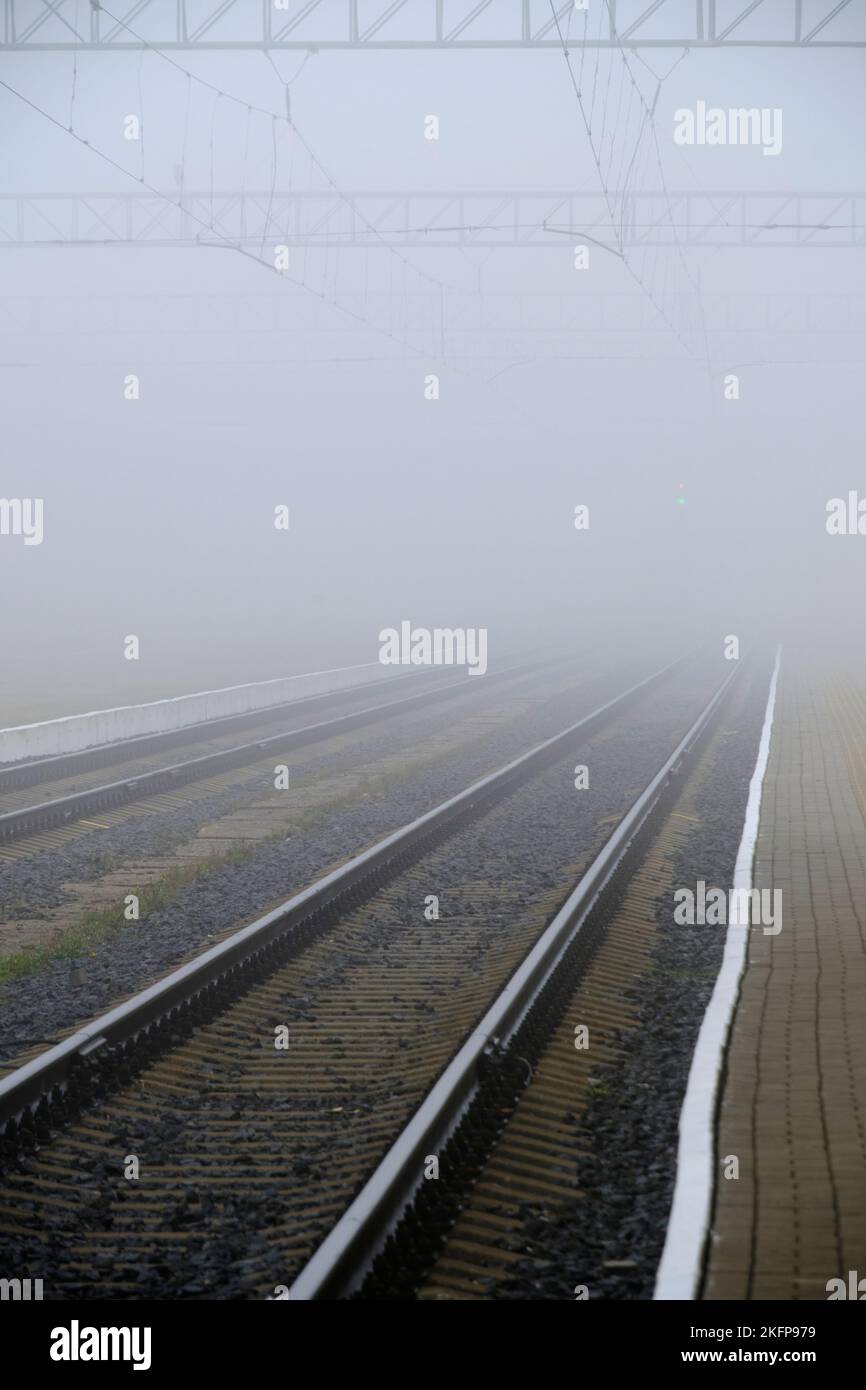 Railway track disappearing into fog.Rails going into fog, atmospheric weather Stock Photo - Alamy