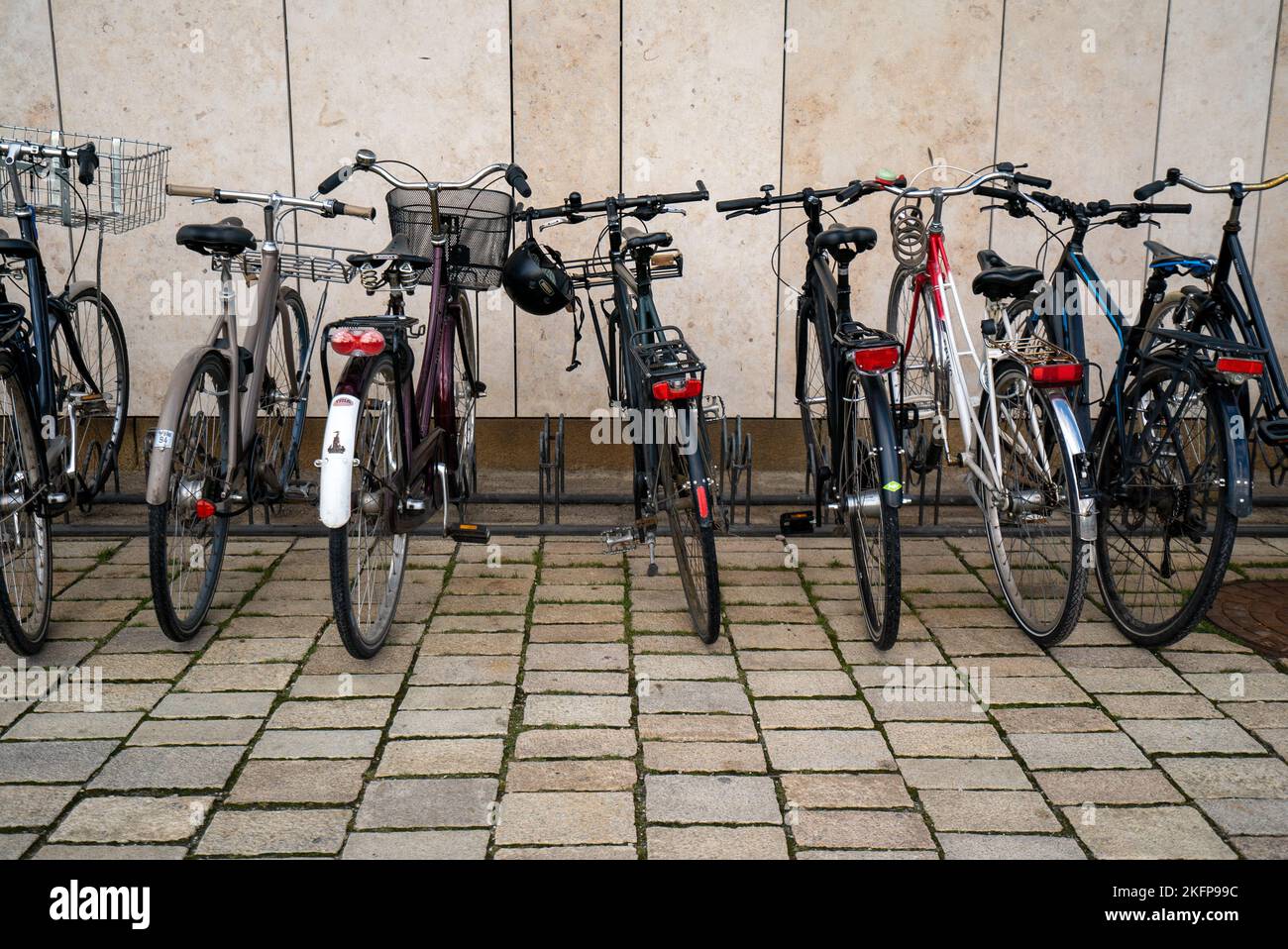 Lots of pedal bikes parked up on a street at a bicycle parking spot in ...
