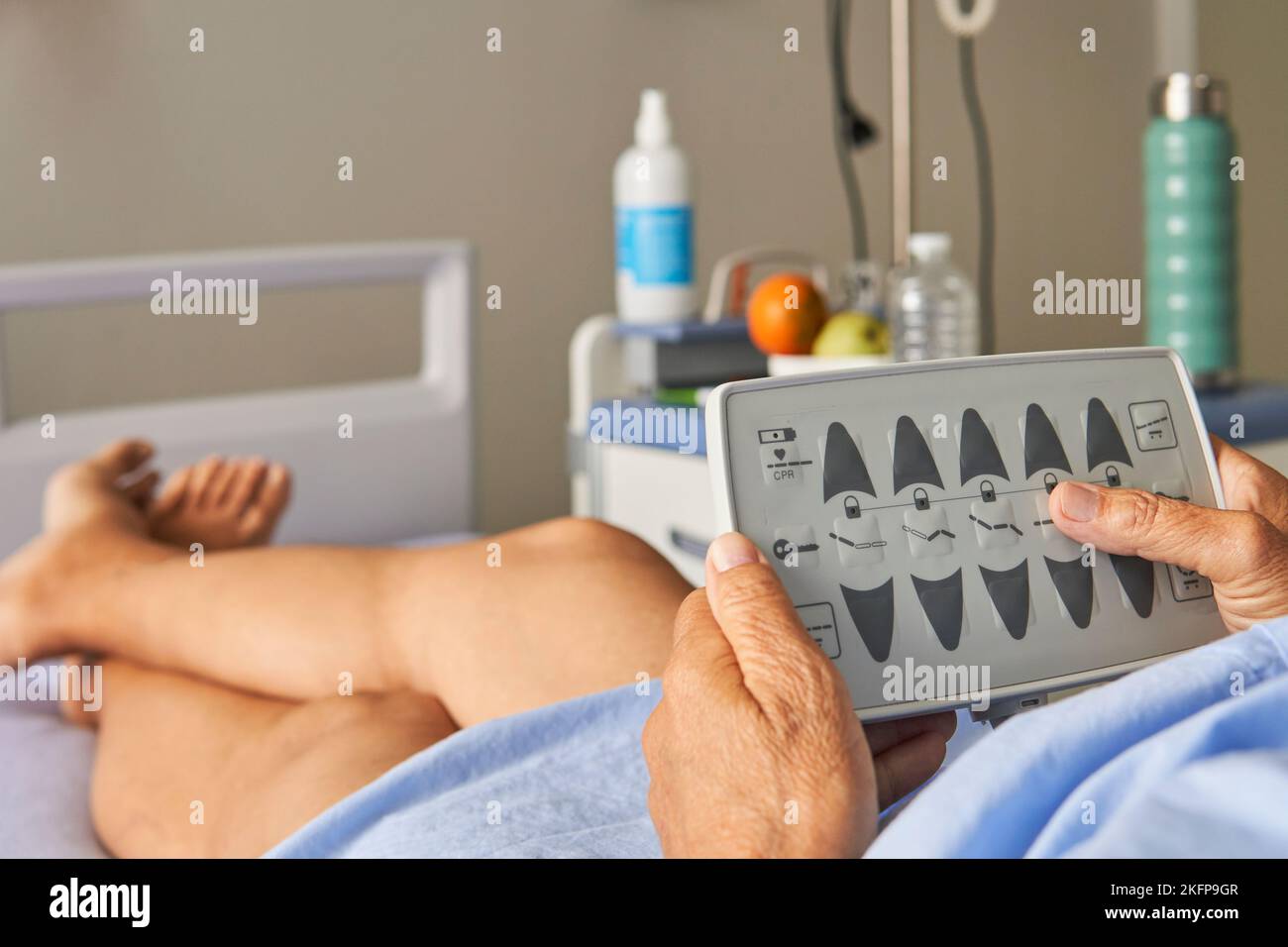 happy senior lady in the hospital room sitting on the stretcher reading ...