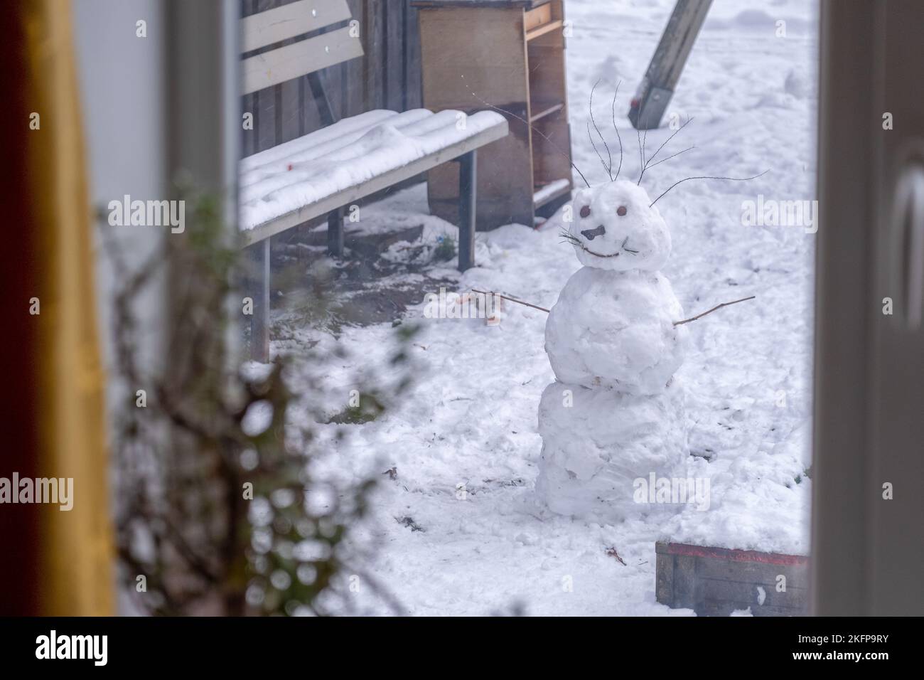 A small snowman made from snow through a window Stock Photo - Alamy