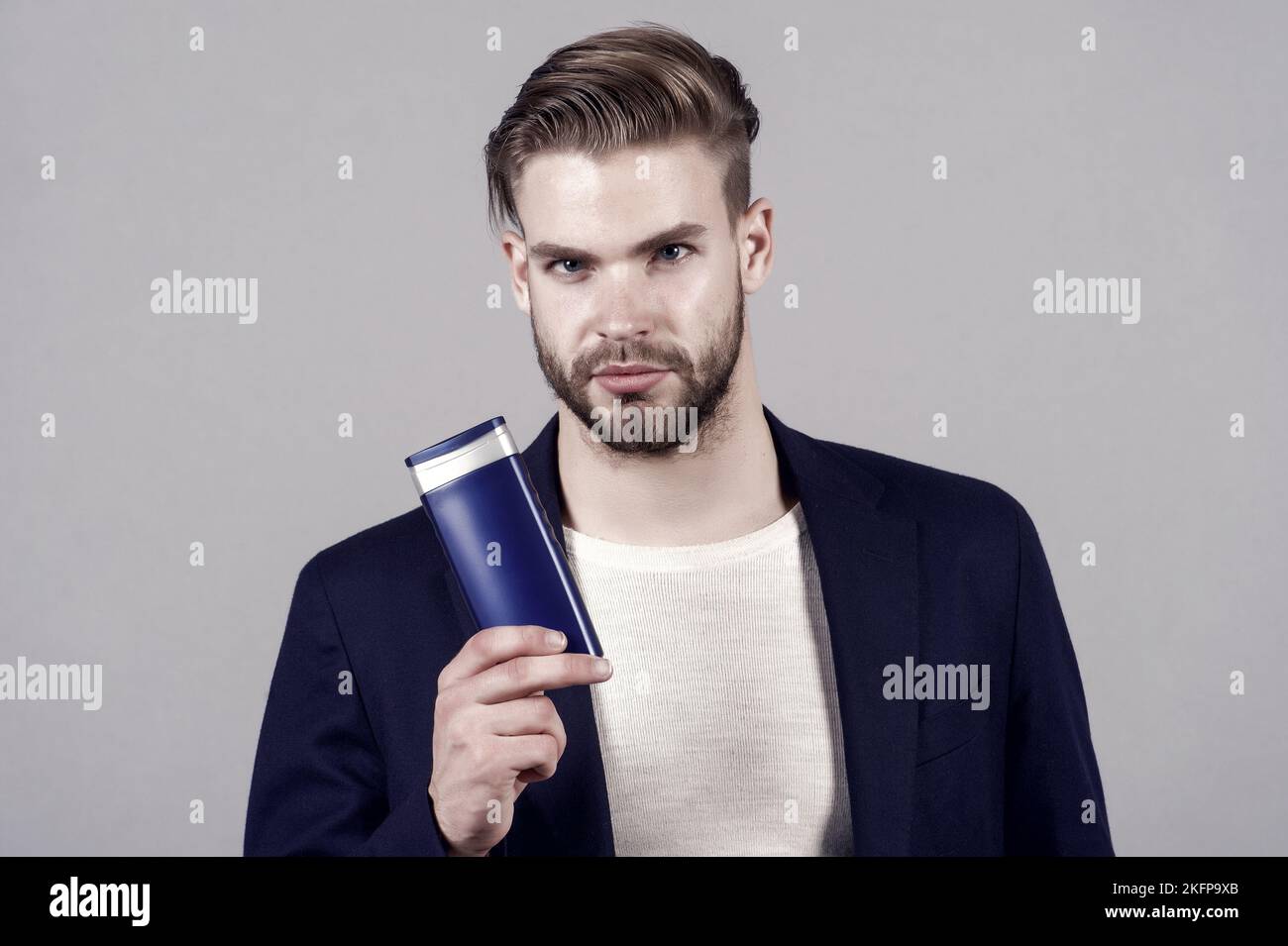 Man with shampoo or conditioner bottle Stock Photo - Alamy