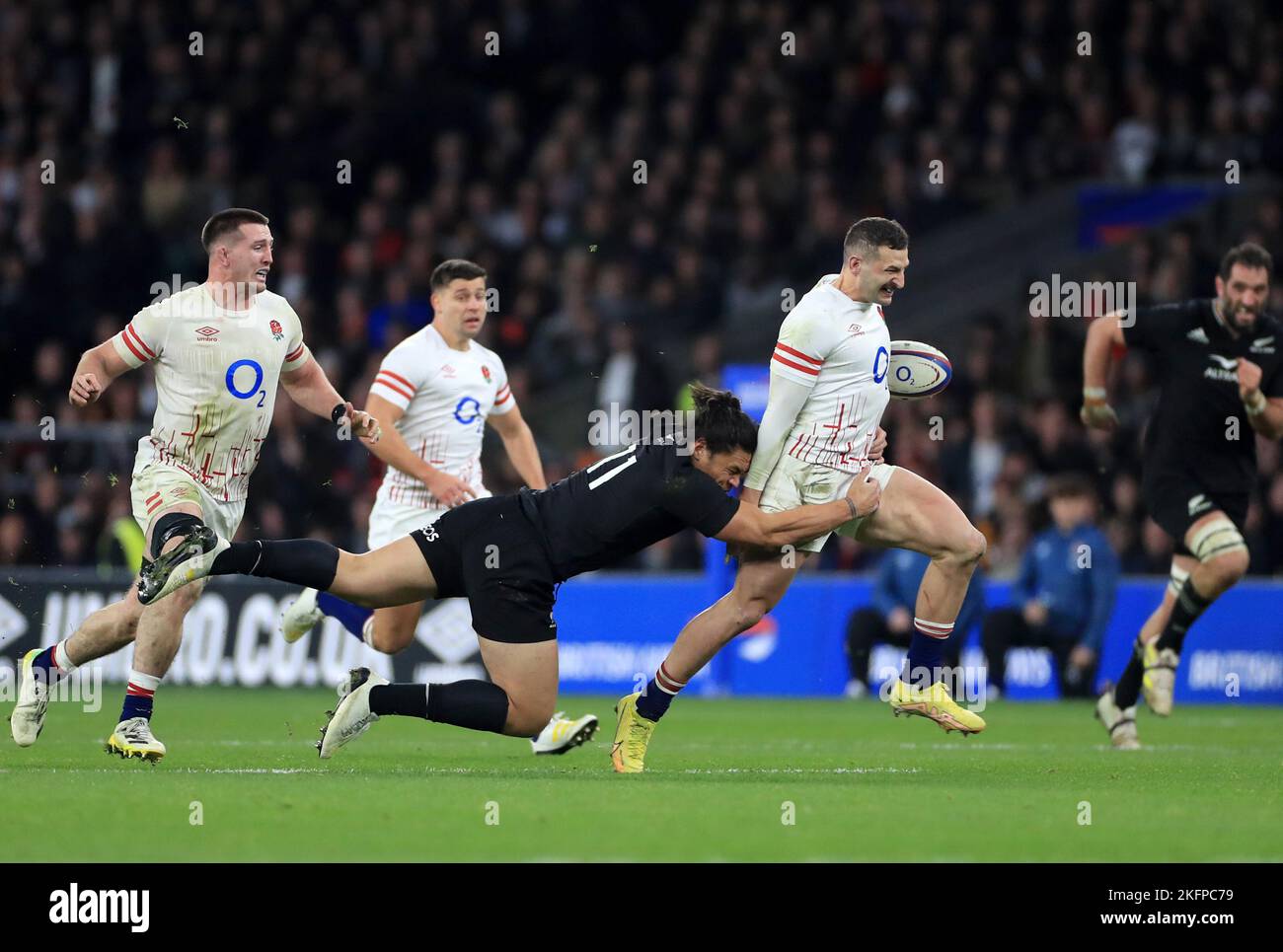 England's Jonny May (right) is tackled by New Zealand's Caleb Clarke ...