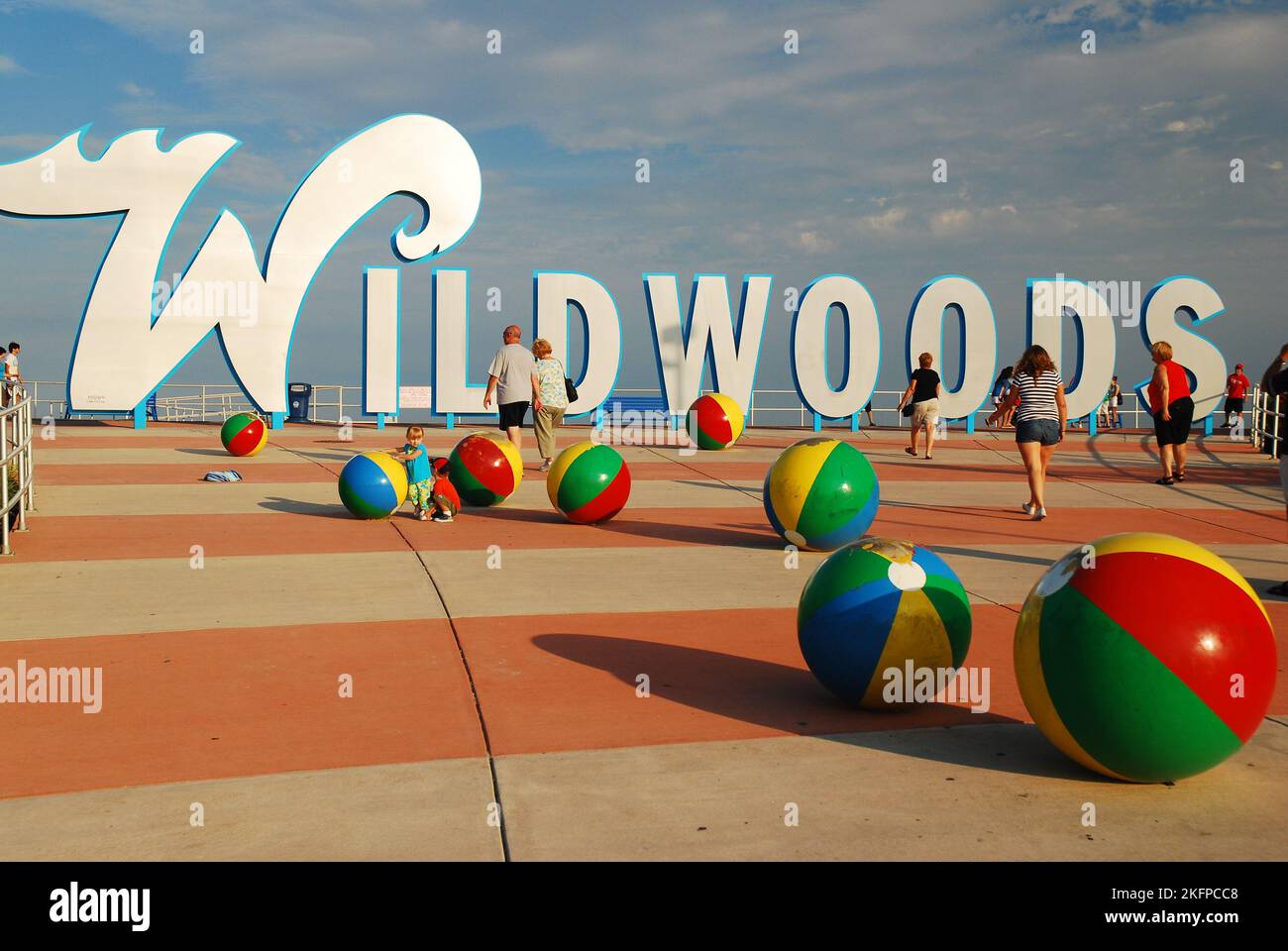 People walk through a pavilion decorated with beach balls, before ...