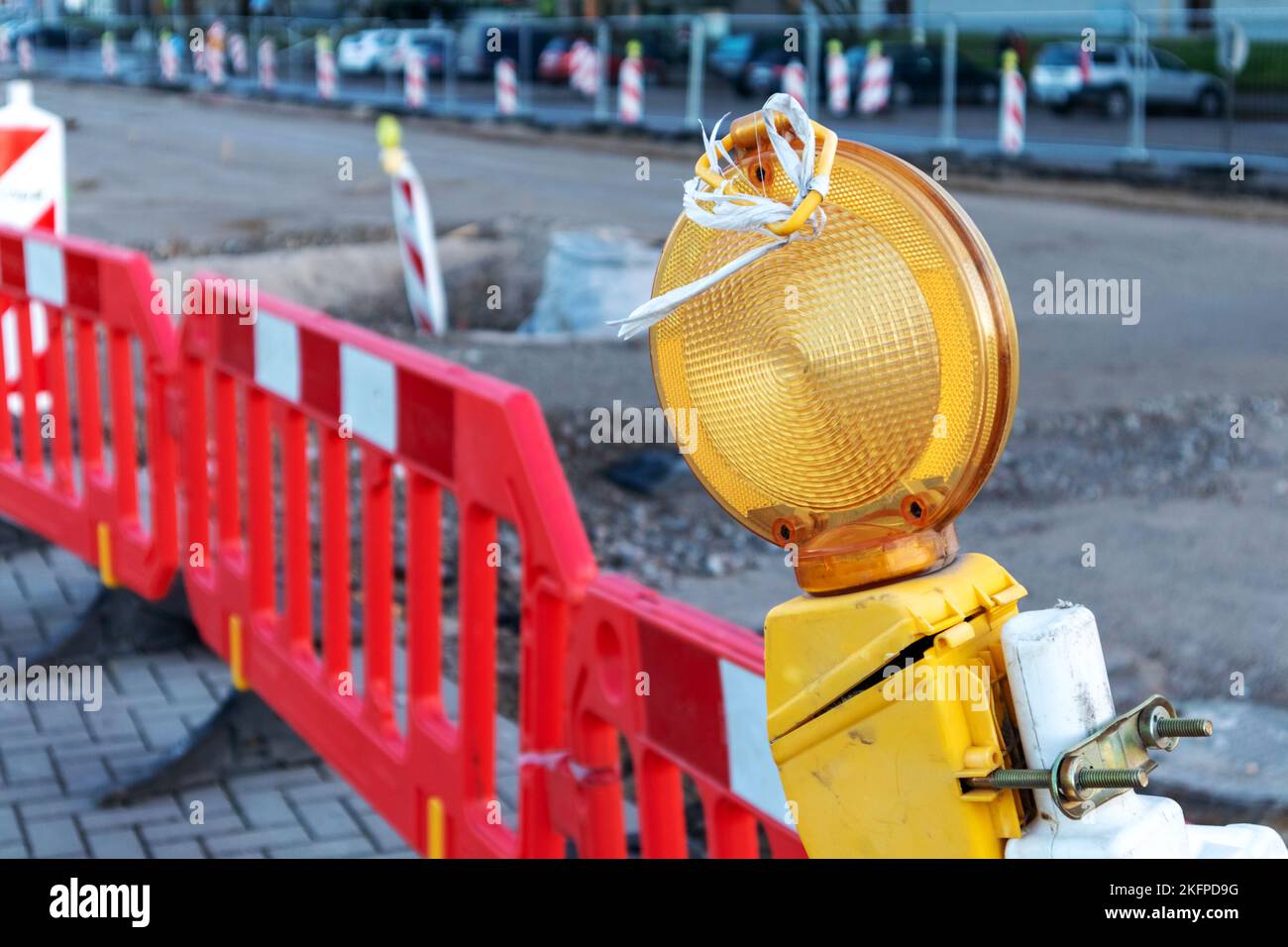 Repair works road signs with red fencing and yellow light Stock Photo ...