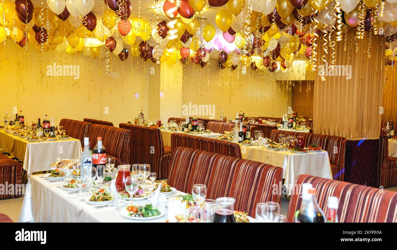tables with food and drinks in cafes and colorful balls on the ceiling ...