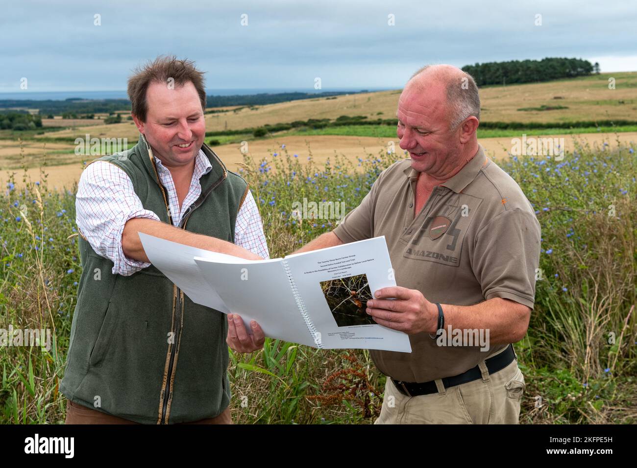 Land agent and farmer discussing farm management on an arable farm in ...