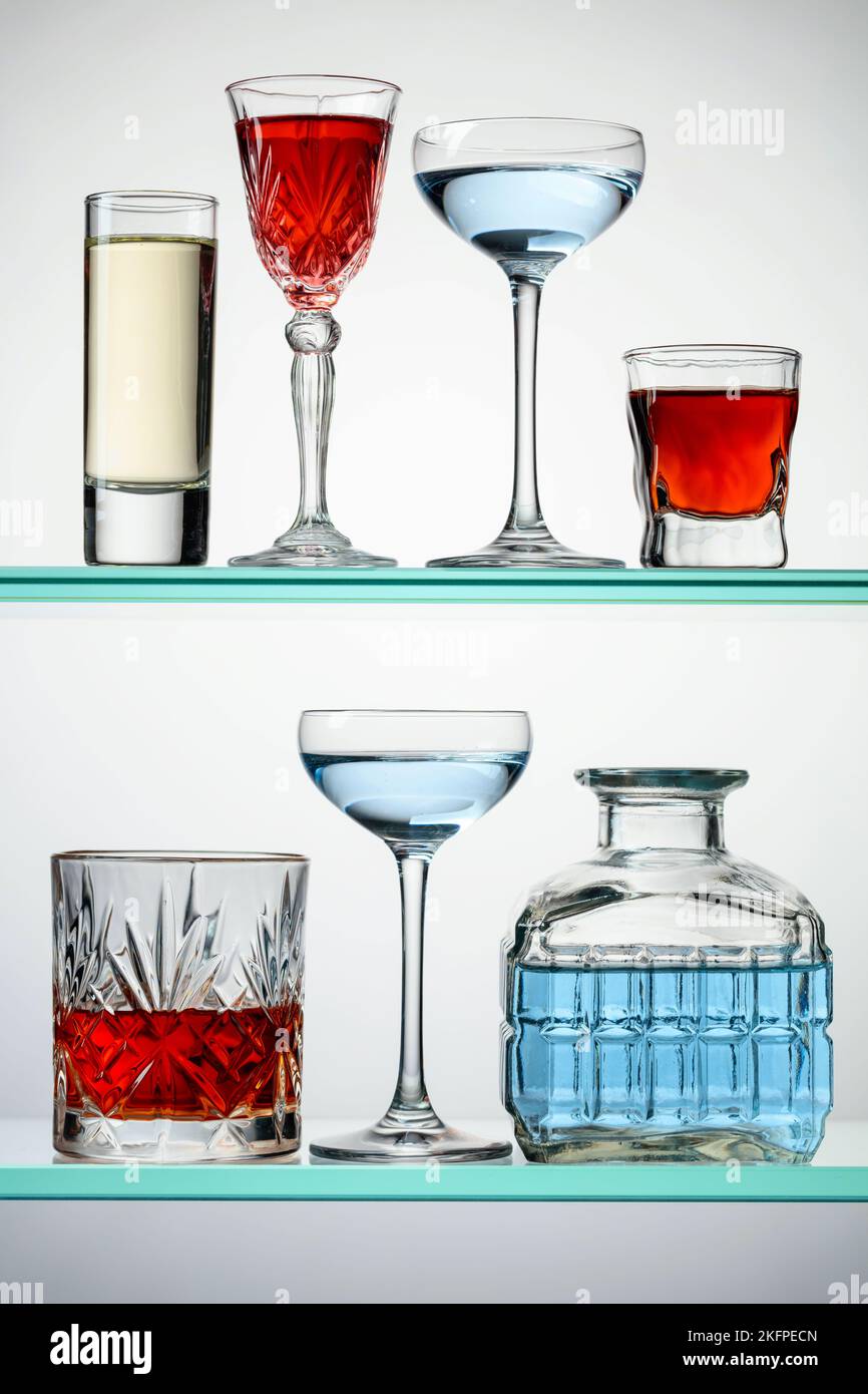 Various alcoholic drinks in the bar on glass shelves Stock Photo - Alamy