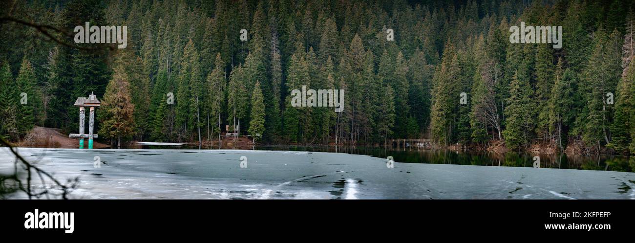 Alpine lake Synevyr, wooden statues near the lake, a tourist place in ...
