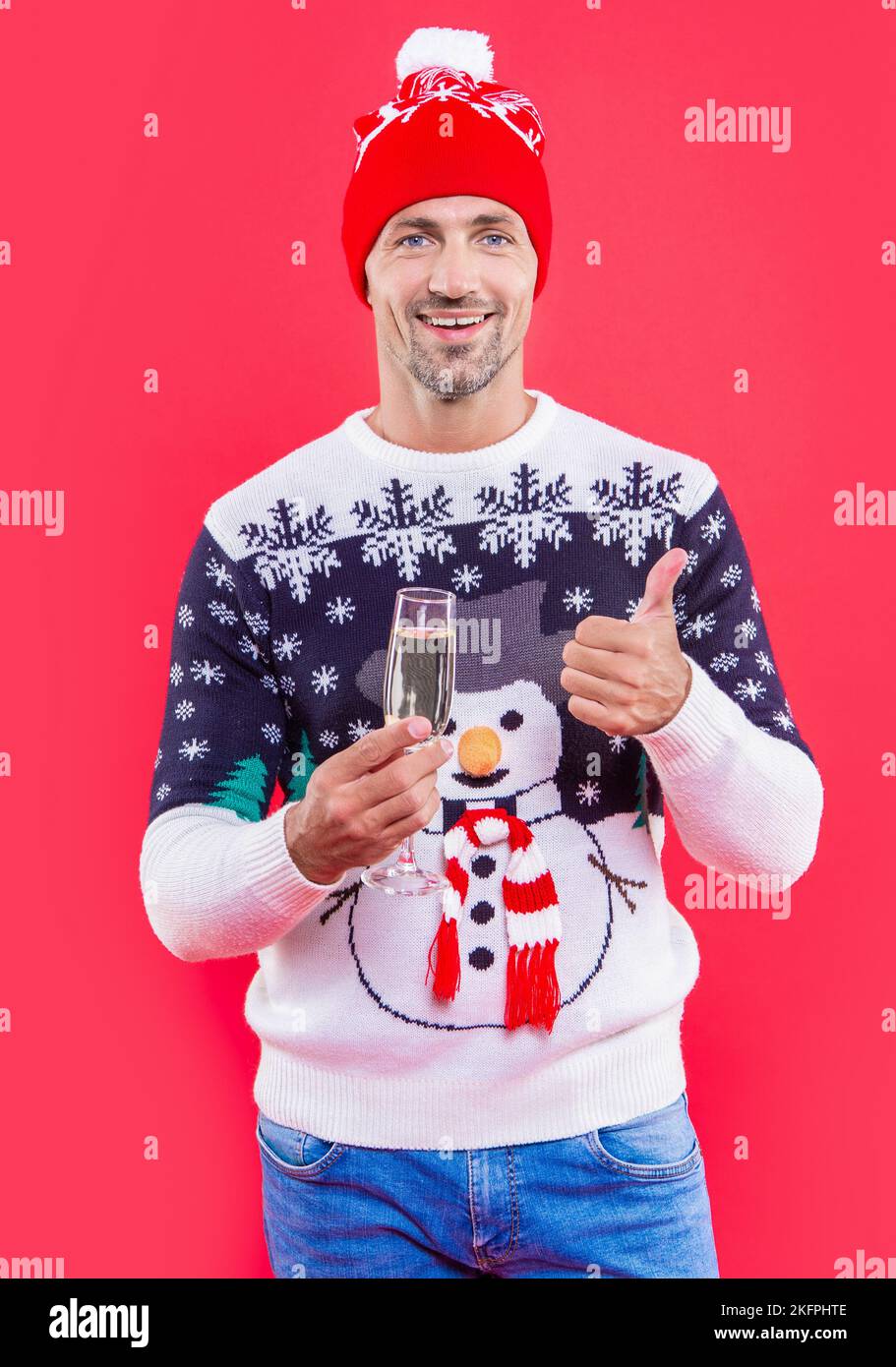 man hold champagne for xmas show thumb up in studio. xmas champagne and ...