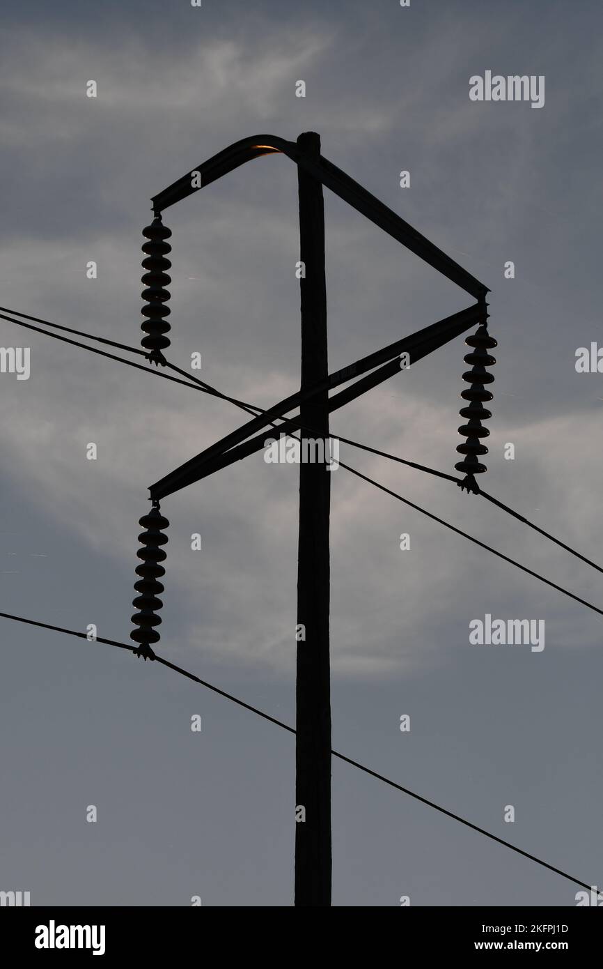 A vertical of an electrical tower with power lines running through it ...