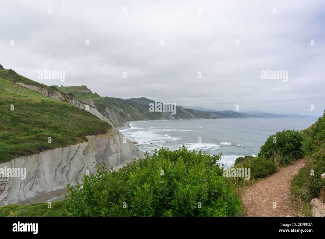 Hiking trail along cliffs in Zumaia Spain with flysch rock formations ...
