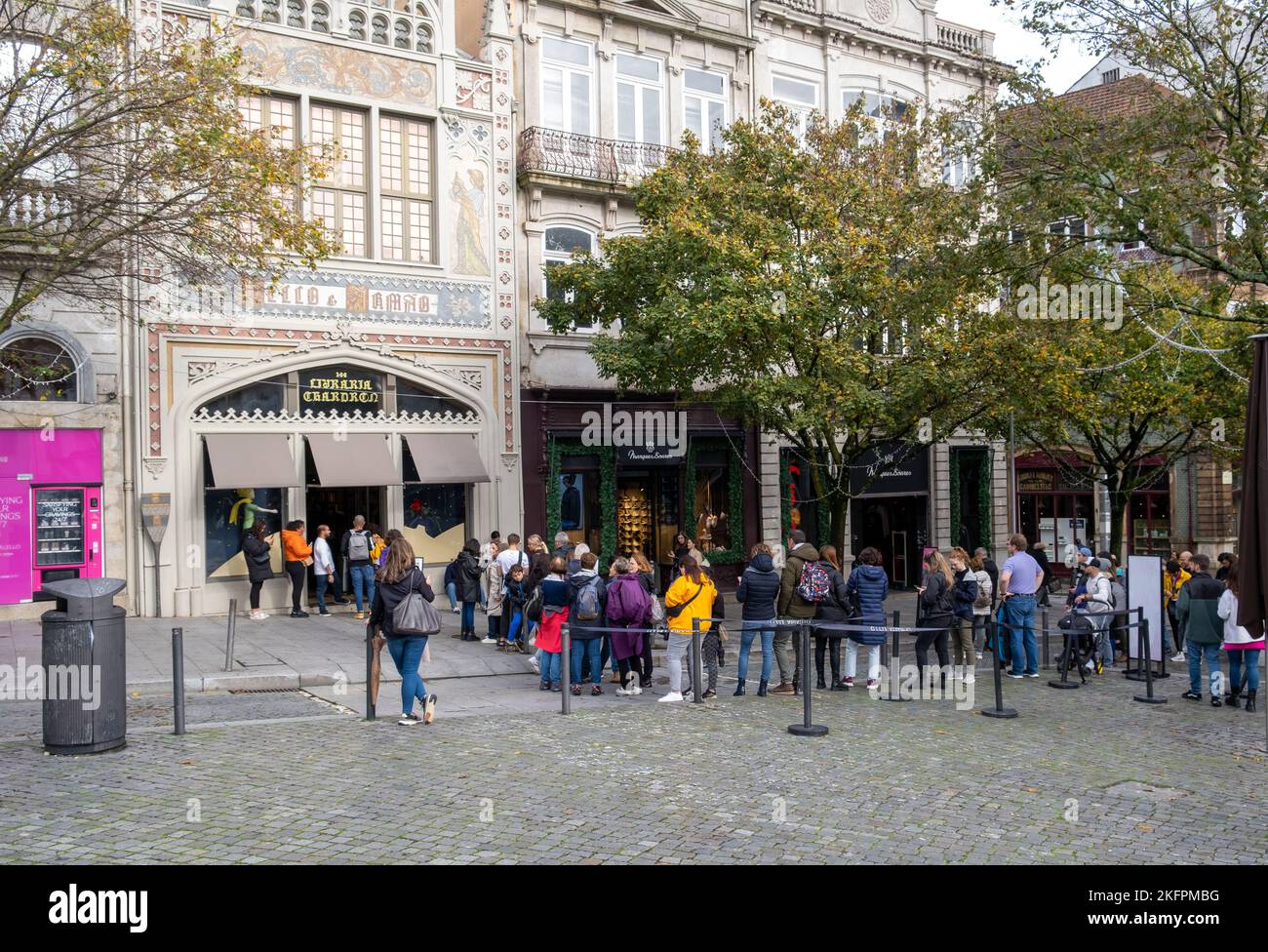 A line of people waiting to walk into the famous old Livraria Lello ...