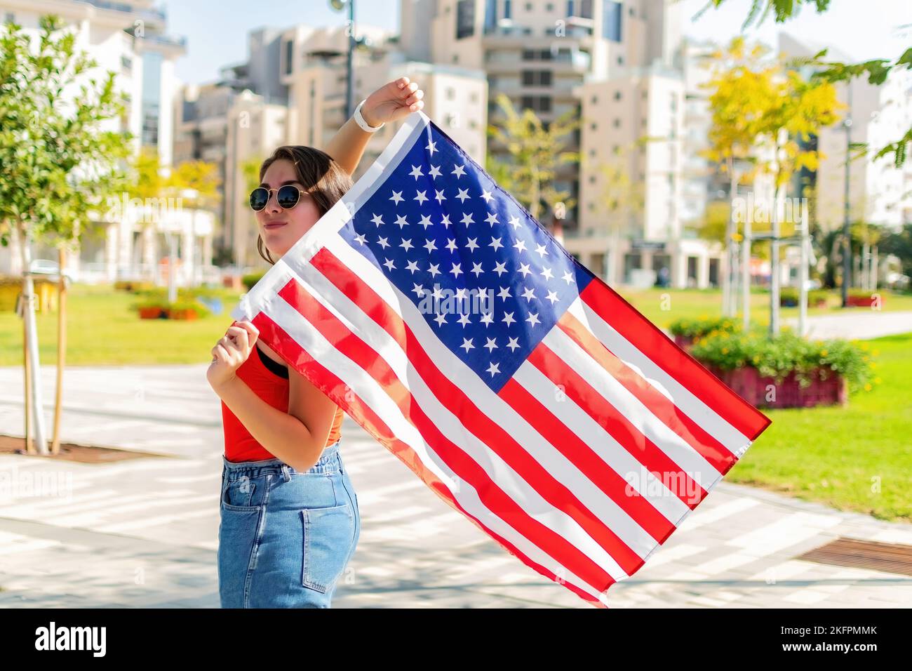 A selective focus of a woman waving an American flag during the US Independence Day on the 4th ...