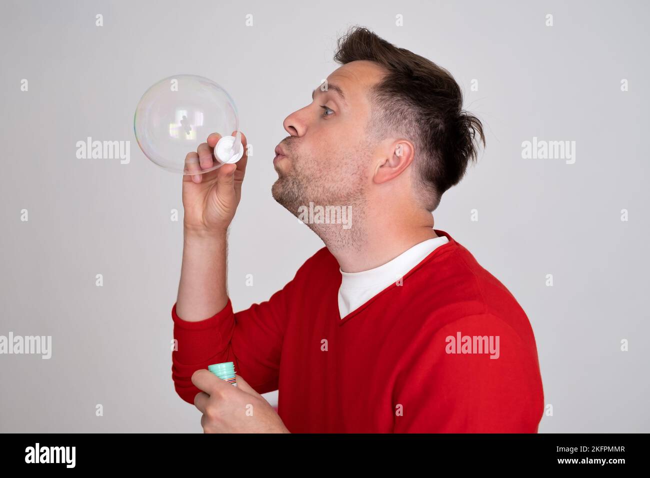 A mature man inflates soap bubbles like a child Stock Photo - Alamy