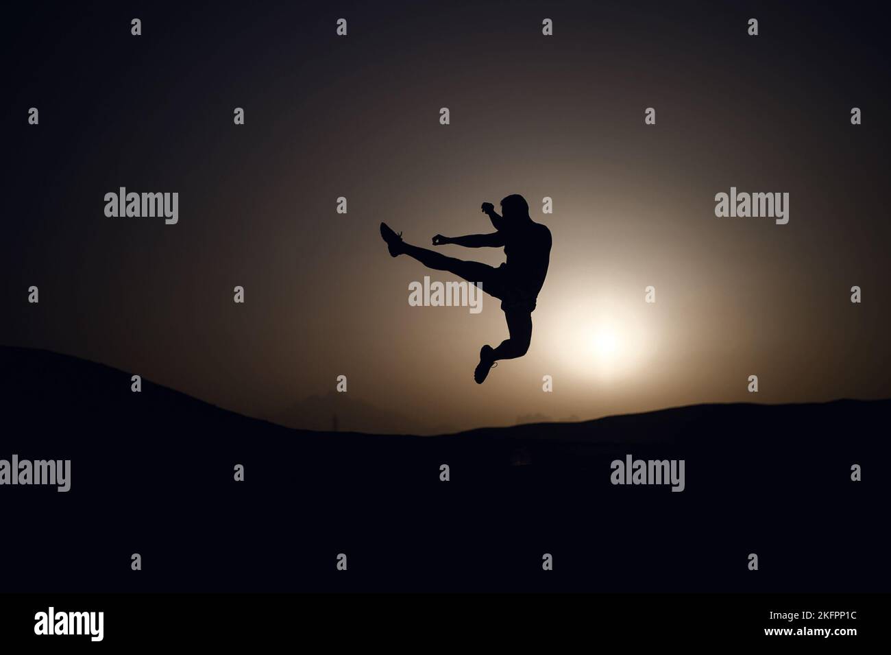 Athlete jump high with energy. Sportsman silhouette on sunset sky. Man ...
