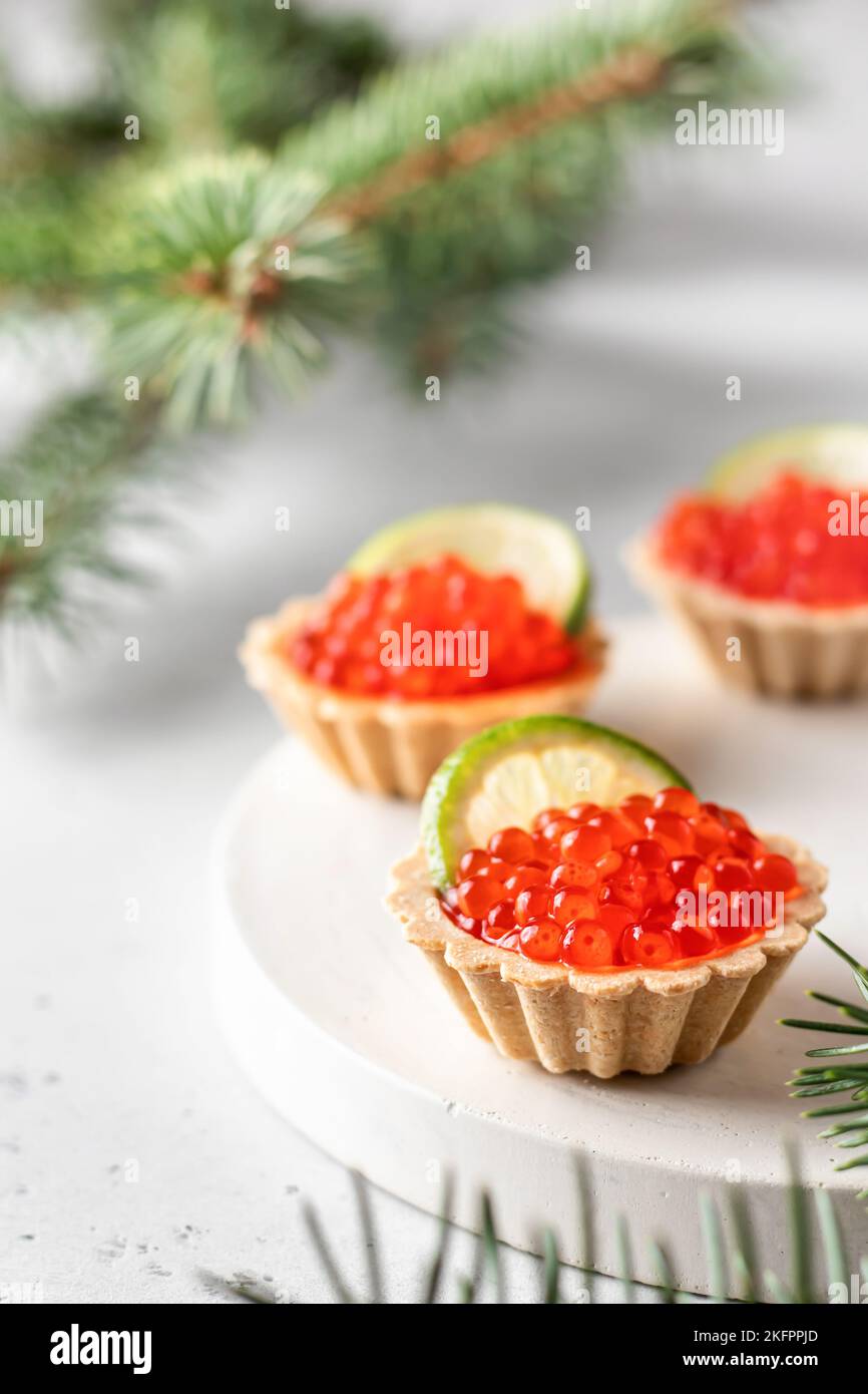 Festive Christmas appetizer tartlets stuffed with red caviar and a ...