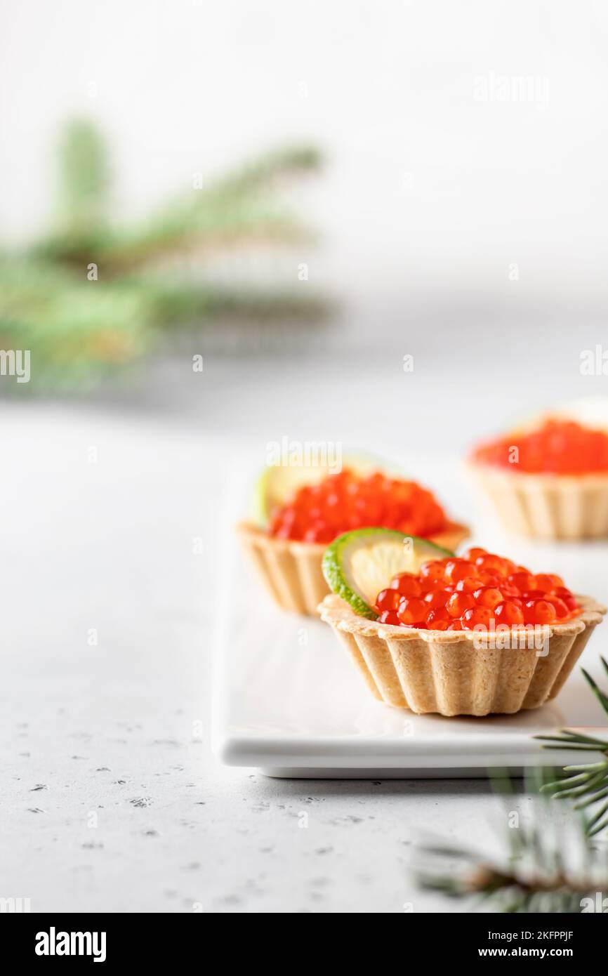 Festive Christmas appetizer tartlets stuffed with red caviar and a ...