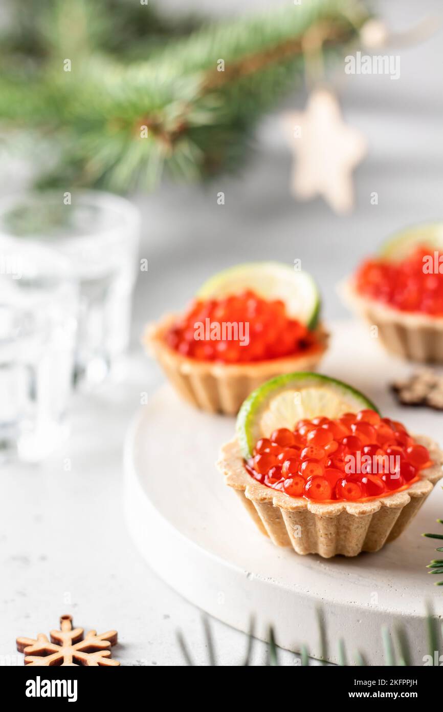 Festive Christmas appetizer tartlets stuffed with red caviar and a ...