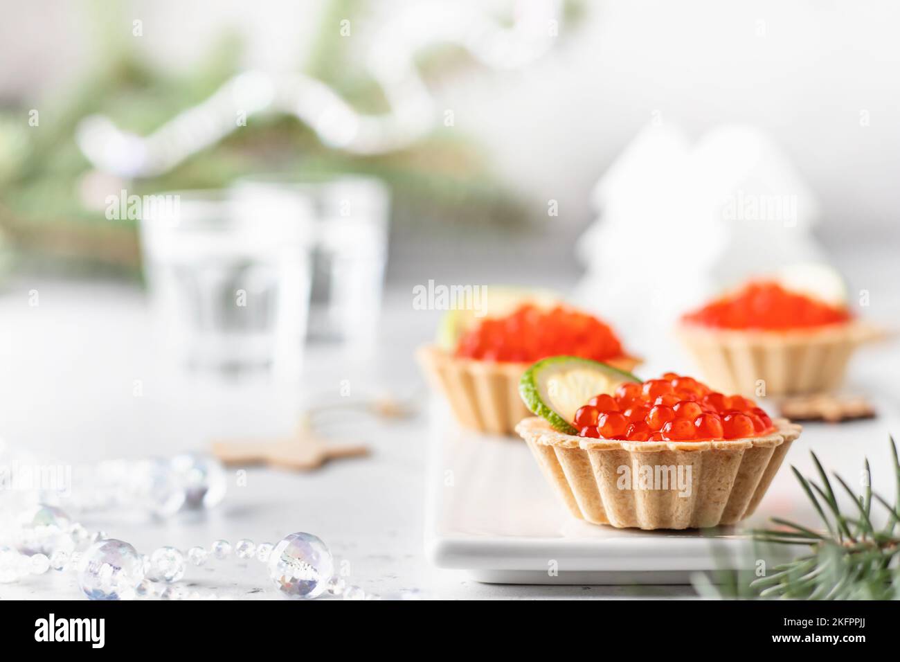 Festive Christmas appetizer tartlets stuffed with red caviar and a ...