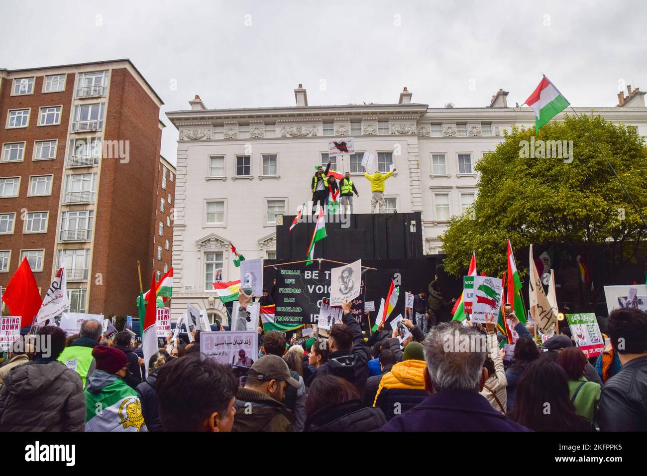 London, UK. 19th November 2022. A group of protesters climb on top of a ...