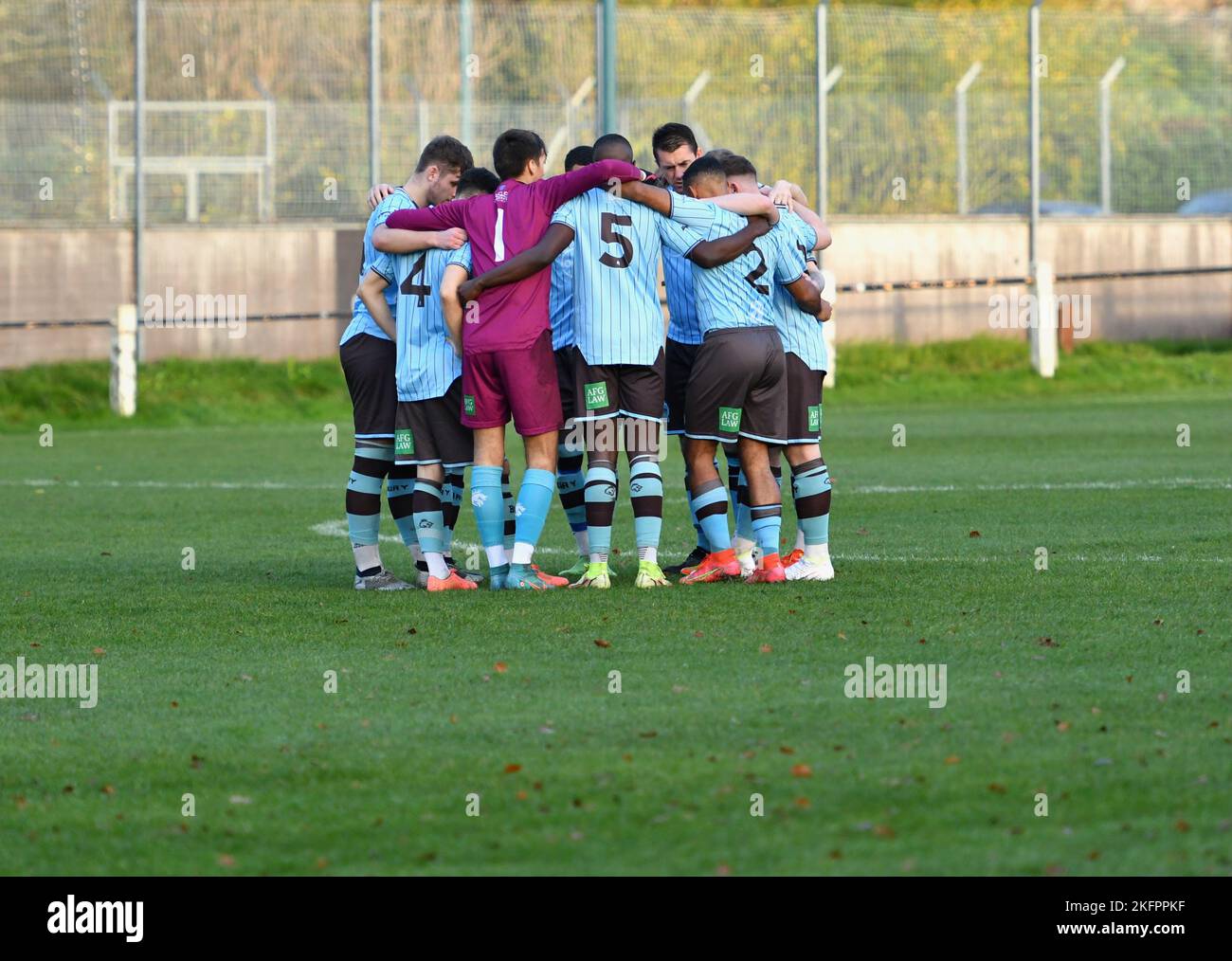 The Bury AFC team huddles before a cup-tie against New Mills, who win ...