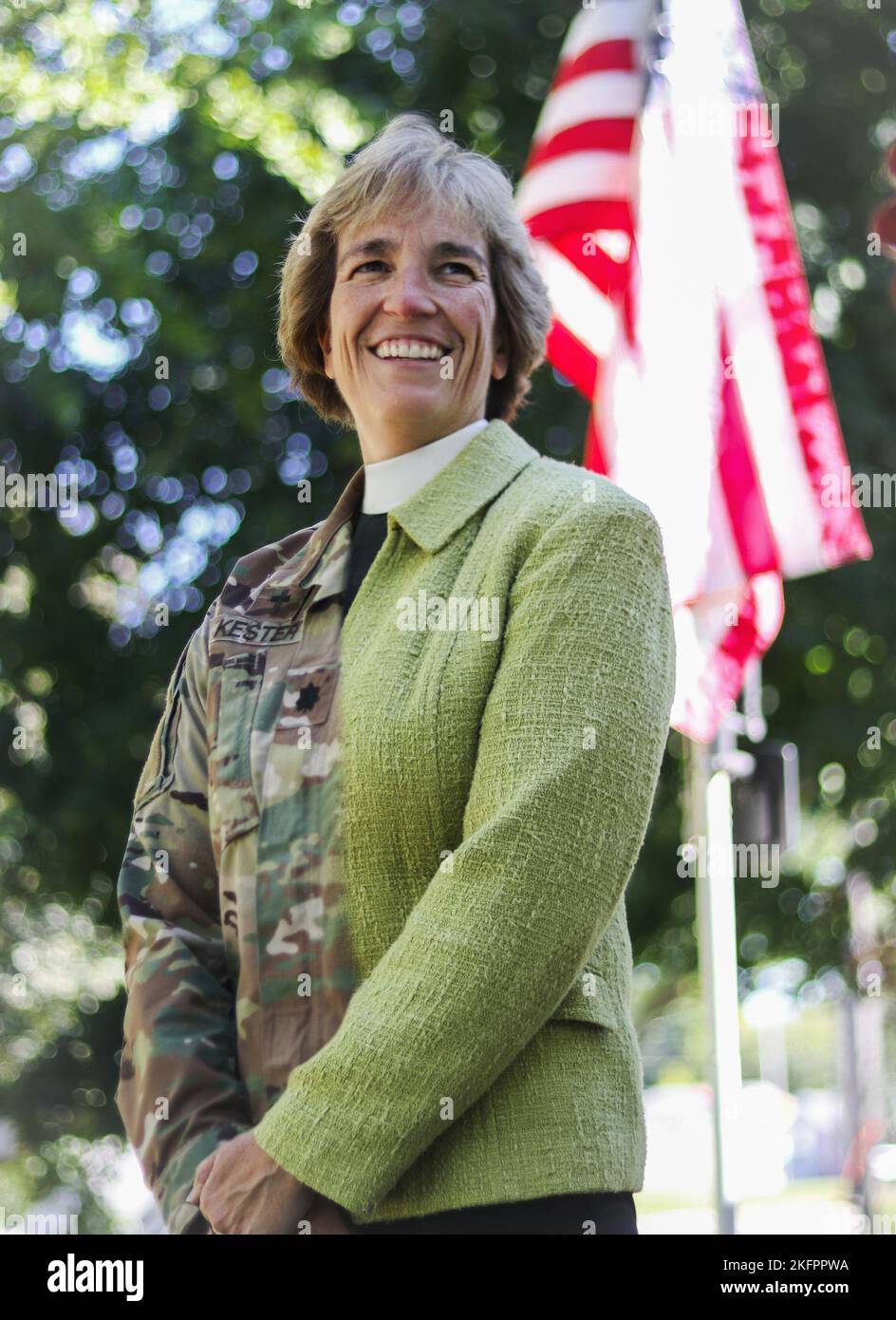 Chaplain (Lt. Col.) Martha Kester smiles in her uniform and parish dress outside her home in Des ...