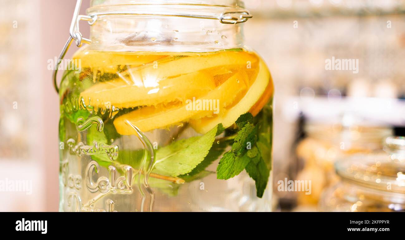 Restaurant bartender pouring lemonade from fruit in glass jars Stock ...