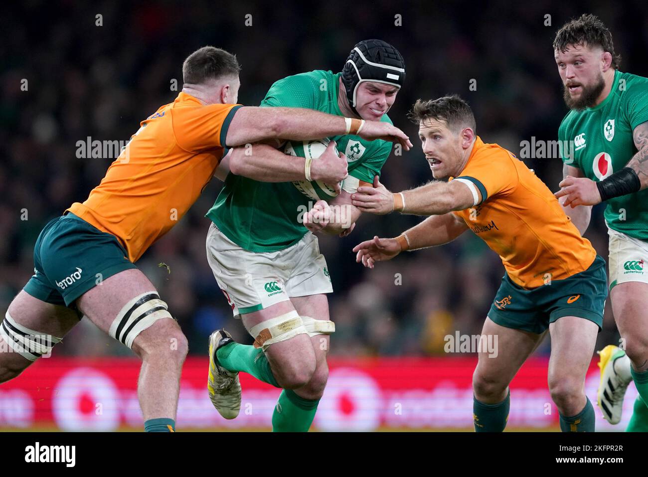 Ireland's James Ryan (centre) is tackled by Australia's Jed Holloway ...