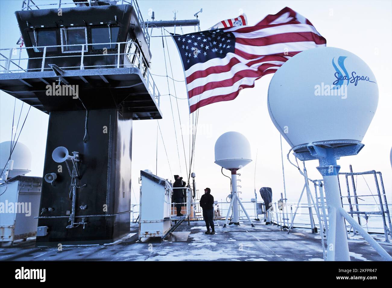 The United States ensign flies aboard the USCGC Healy (WAGB 20) while ...