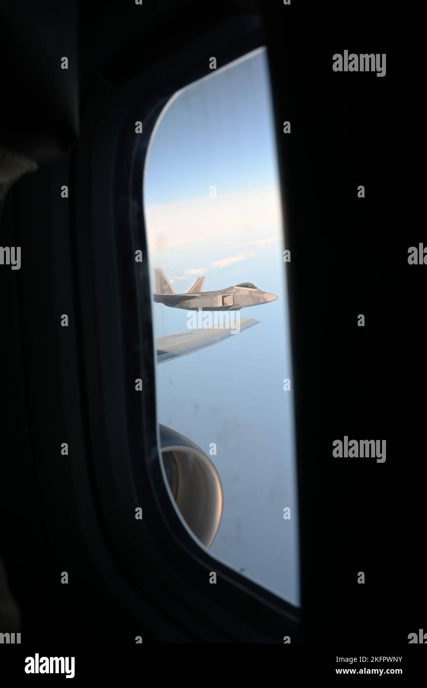 An F-22 Raptor waits for gas just off the wingtip of a KC-46A Pegasus ...