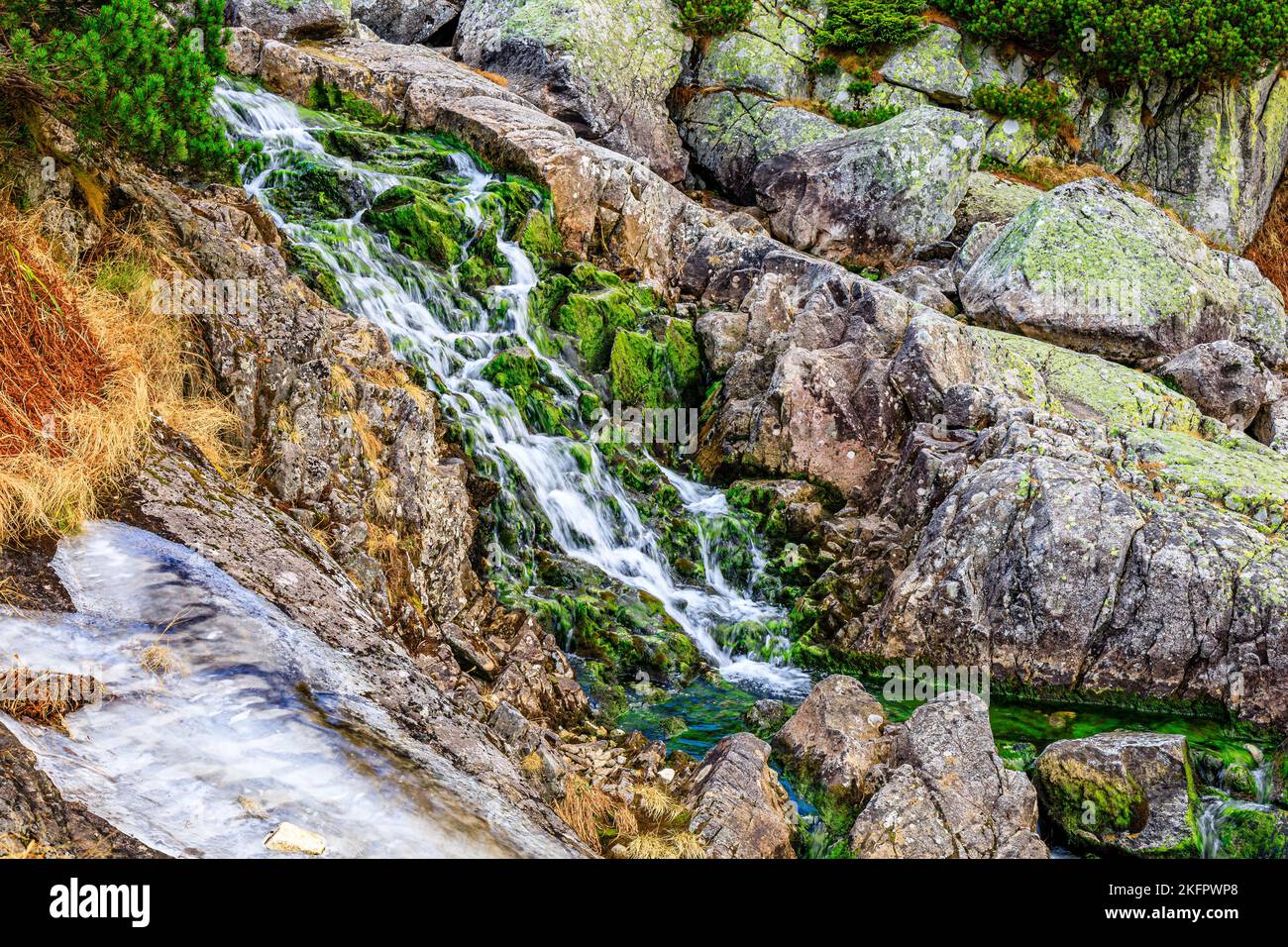 A beautiful landscape of a waterfall falling down a cascade of rocky ...