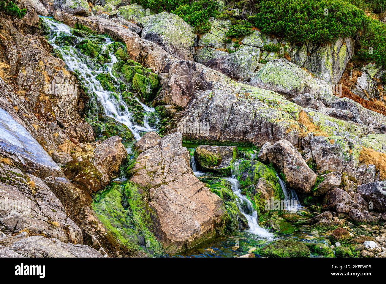 A beautiful landscape of a waterfall falling down a cascade of rocky ...