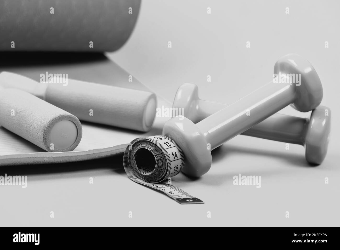 Shaping and fitness. Dumbbells, cyan jump rope and measure tape Stock ...