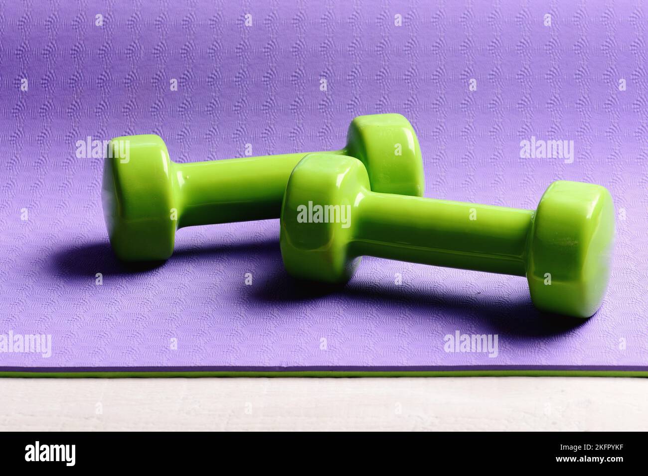 Shaping and fitness equipment. Dumbbells made of green plastic Stock ...