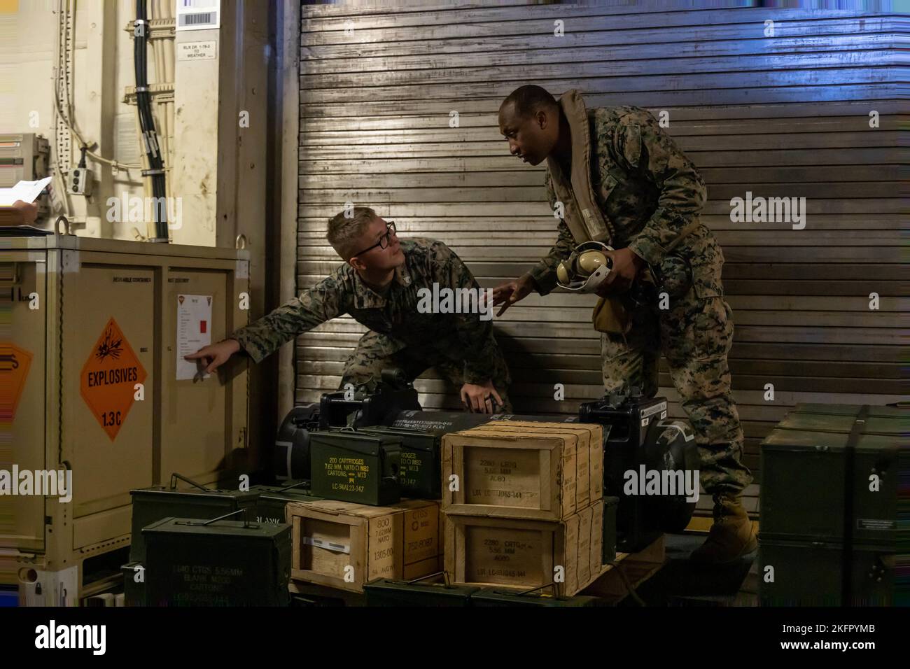 U.S. Marine Corps Sgt. Brandon McGuire, left, an ammo technician with ...