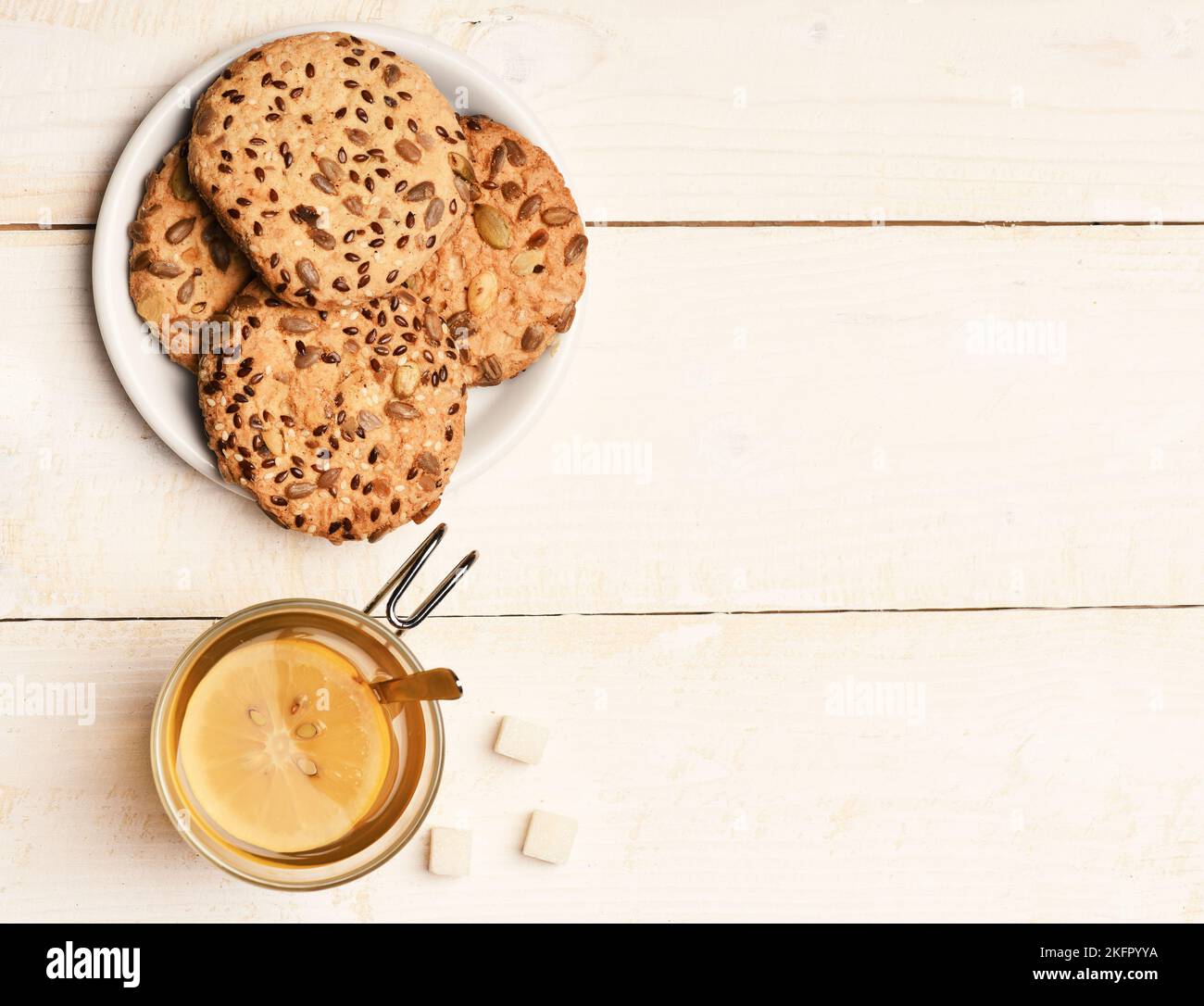 Biscuits with seeds placed near cup of tea and sugar Stock Photo - Alamy