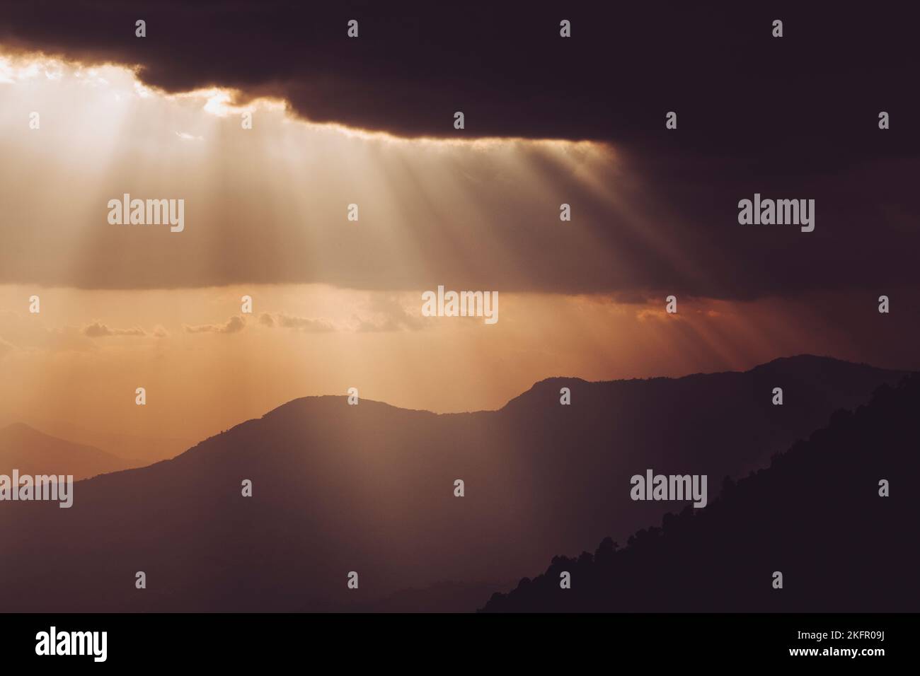 Sun beams over silhouetted Himalayan foothills, south of Annapurna ...