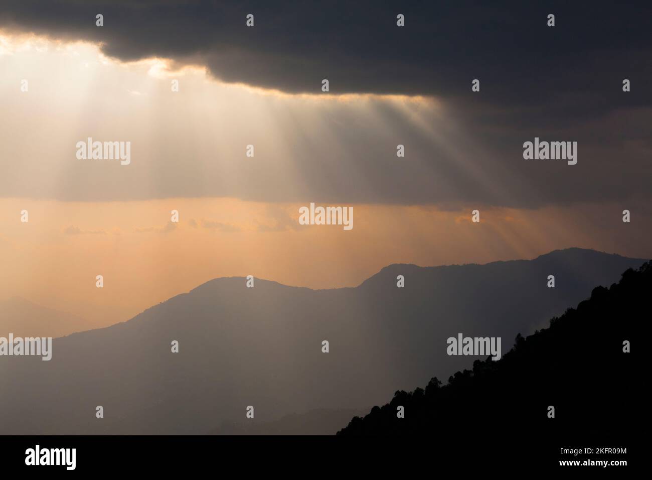 Sun beams over silhouetted Himalayan foothills, south of Annapurna ...