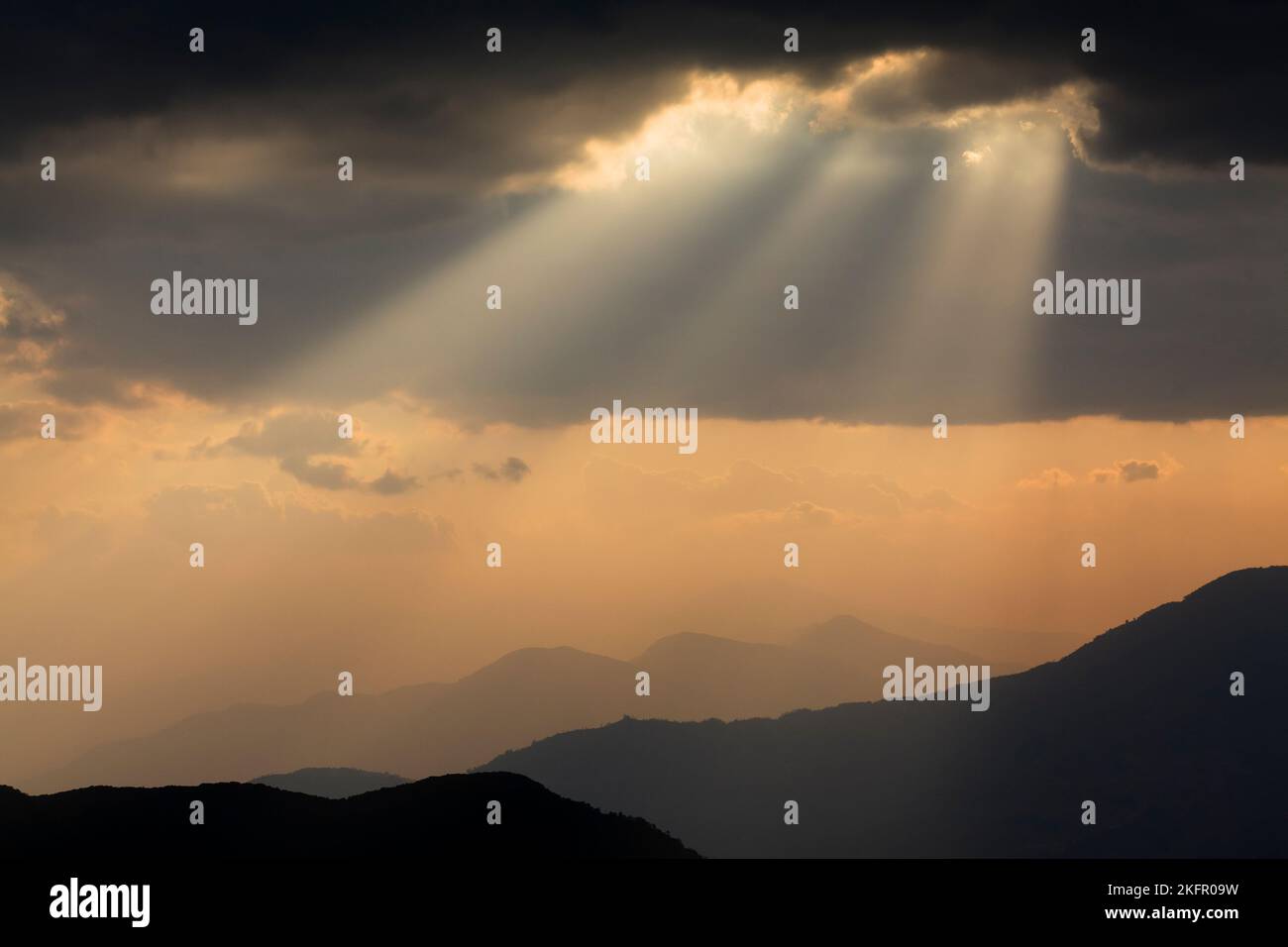 Sun beams over silhouetted Himalayan foothills, south of Annapurna ...