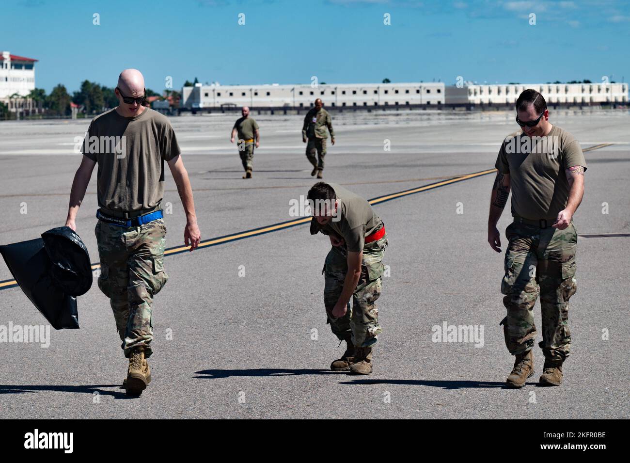 U.S. Airmen assigned to the 6th Maintenance Squadron pick up debris ...