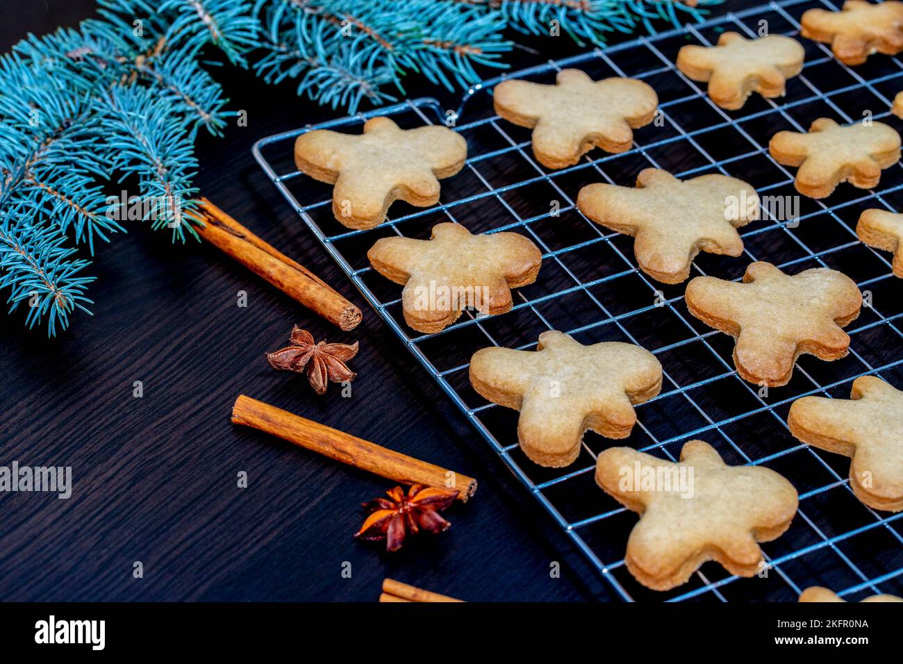 Freshly baked gingerbread man shaped biscuits with Christmas decoration ...