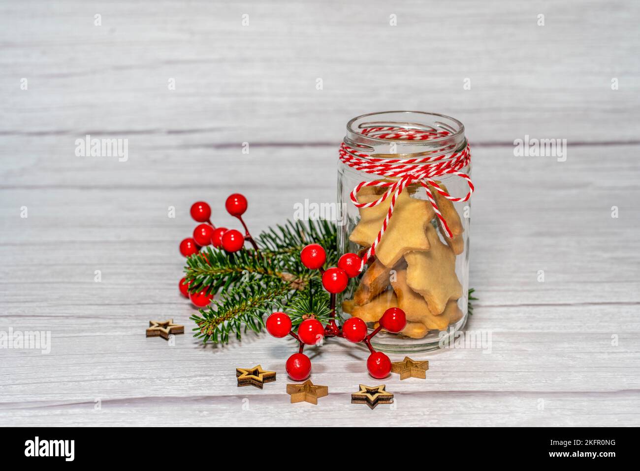 star-shaped jar of homemade cinnamon and vanilla biscuits on table with ...
