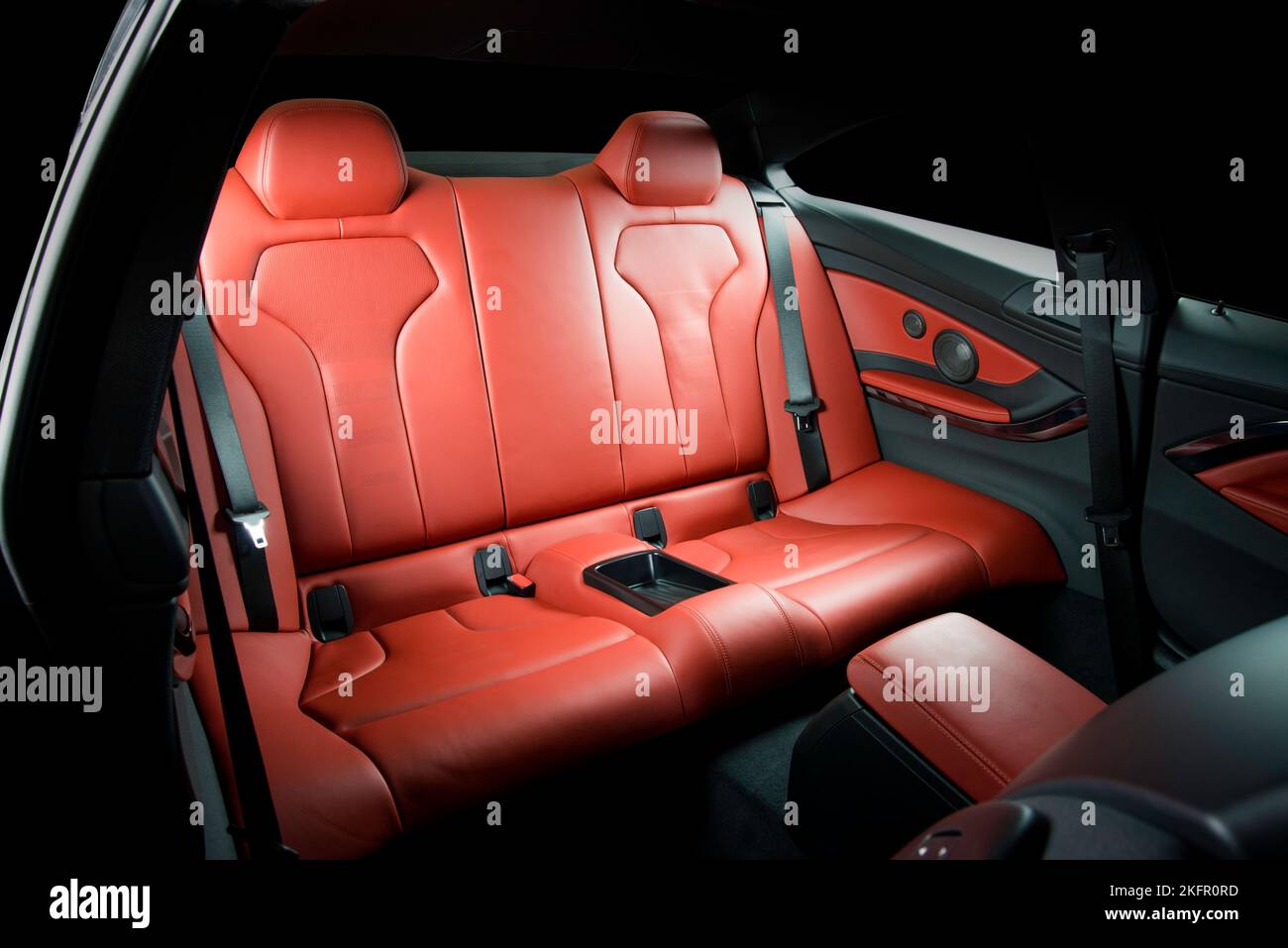 Back passenger seats in modern luxury car, frontal view, red perforated ...